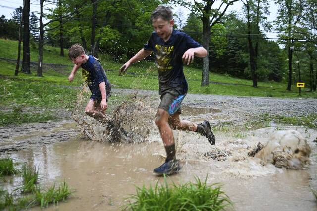 Runners who don’t mind getting soaked, filthy relish Seven Springs’ Mud ...